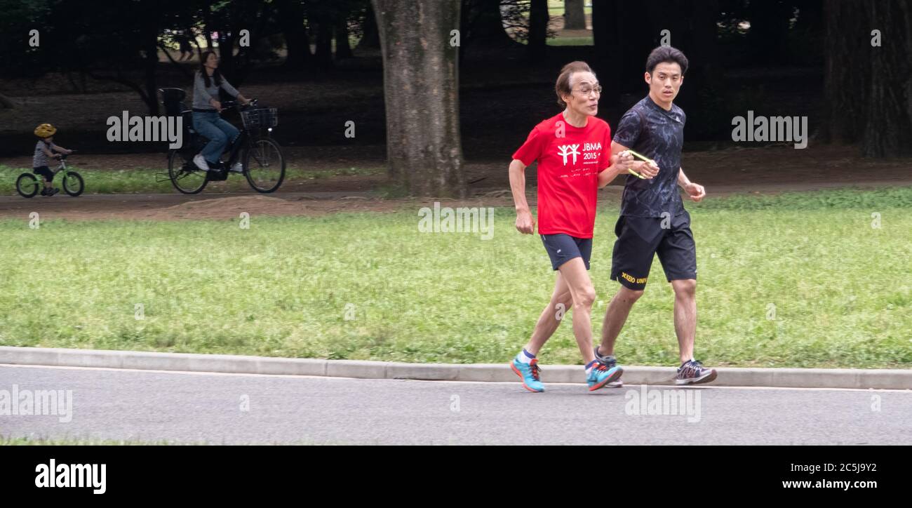 Visually impaired runner with running guide in Yoyogi Park, Tokyo ...