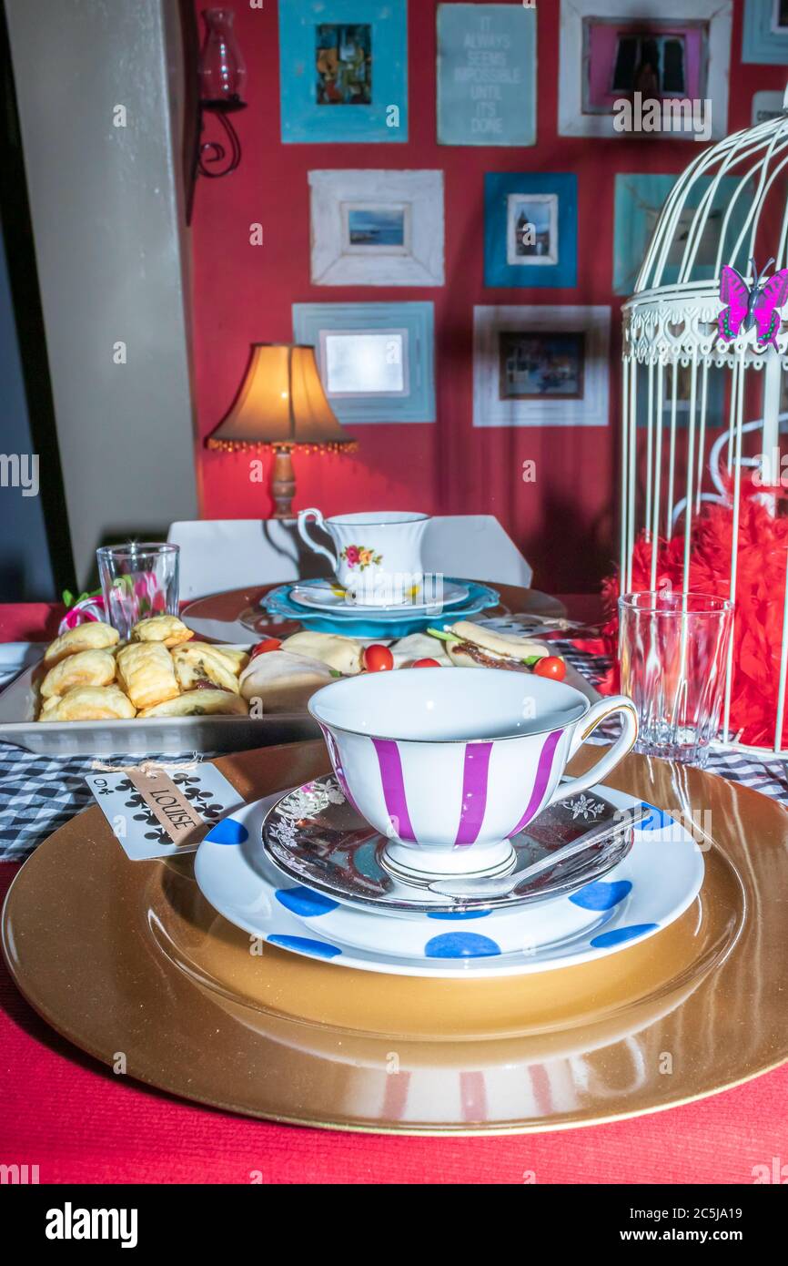 Colorful Tea party with table laid out fancy tea cups and saucers, with ...