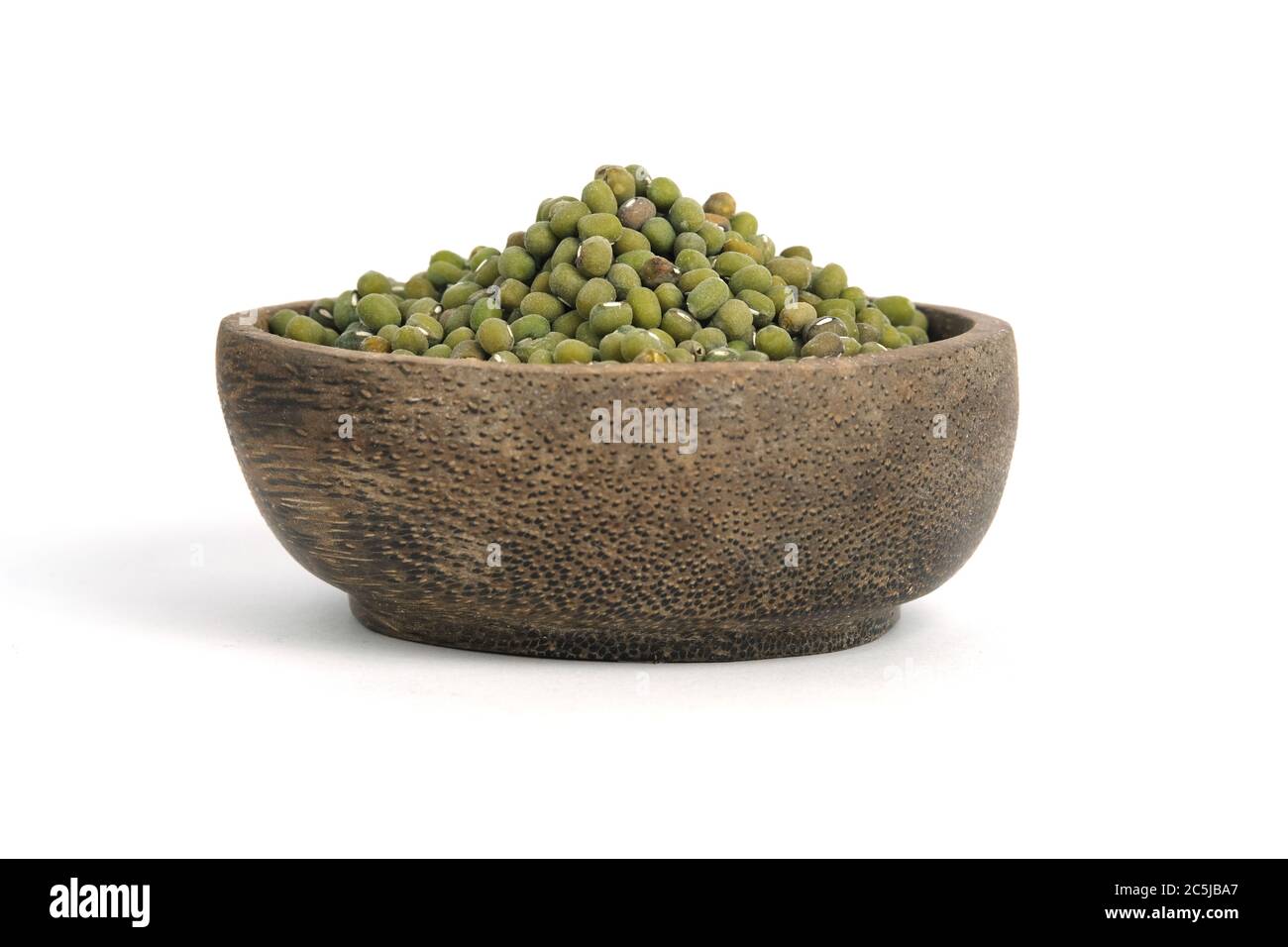 Raw green mung seed on wooden bowl isolated on a white background with ...