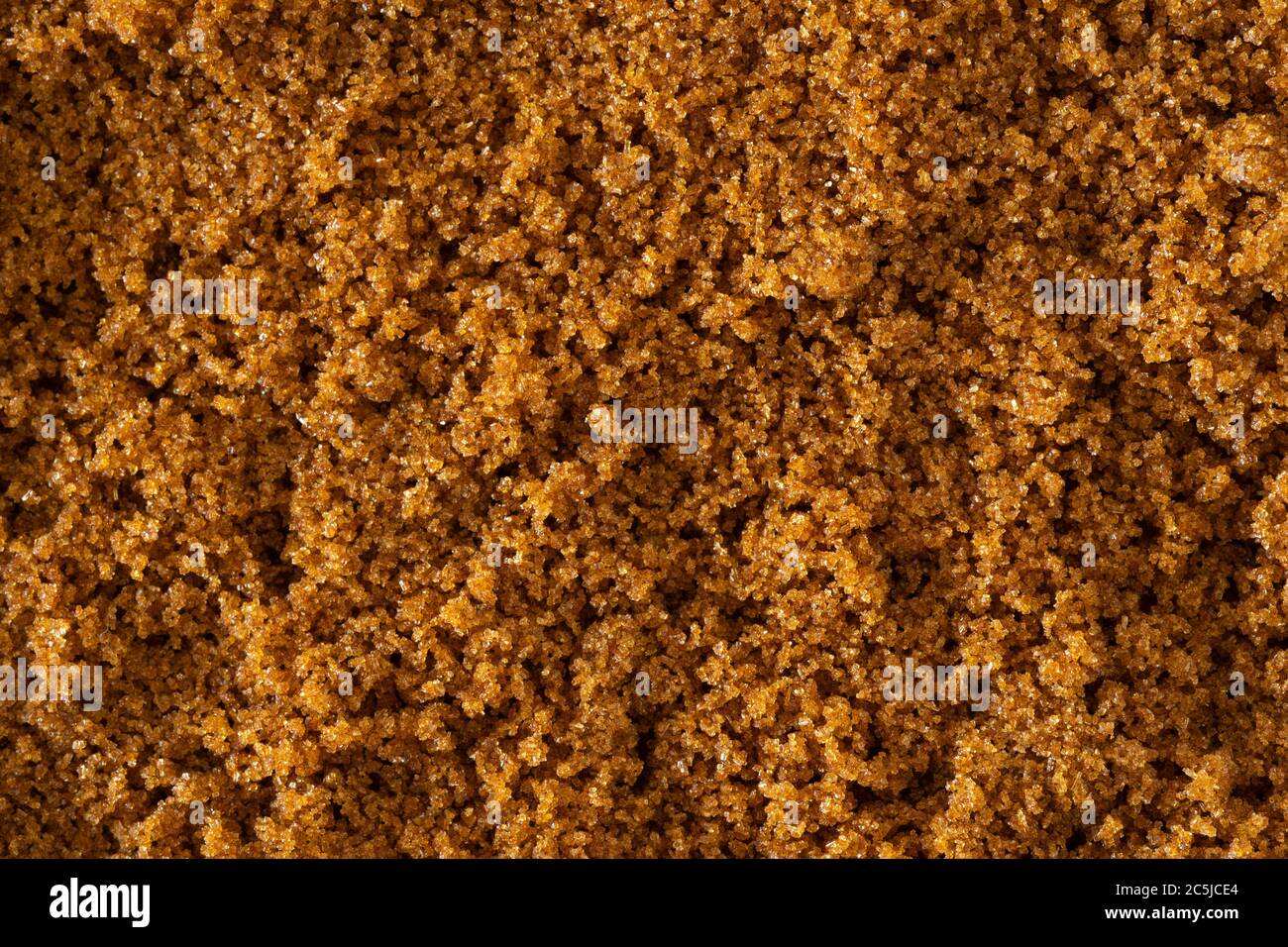 A macro closeup of Muscovado sugar - unrefined cane sugar that contains ...