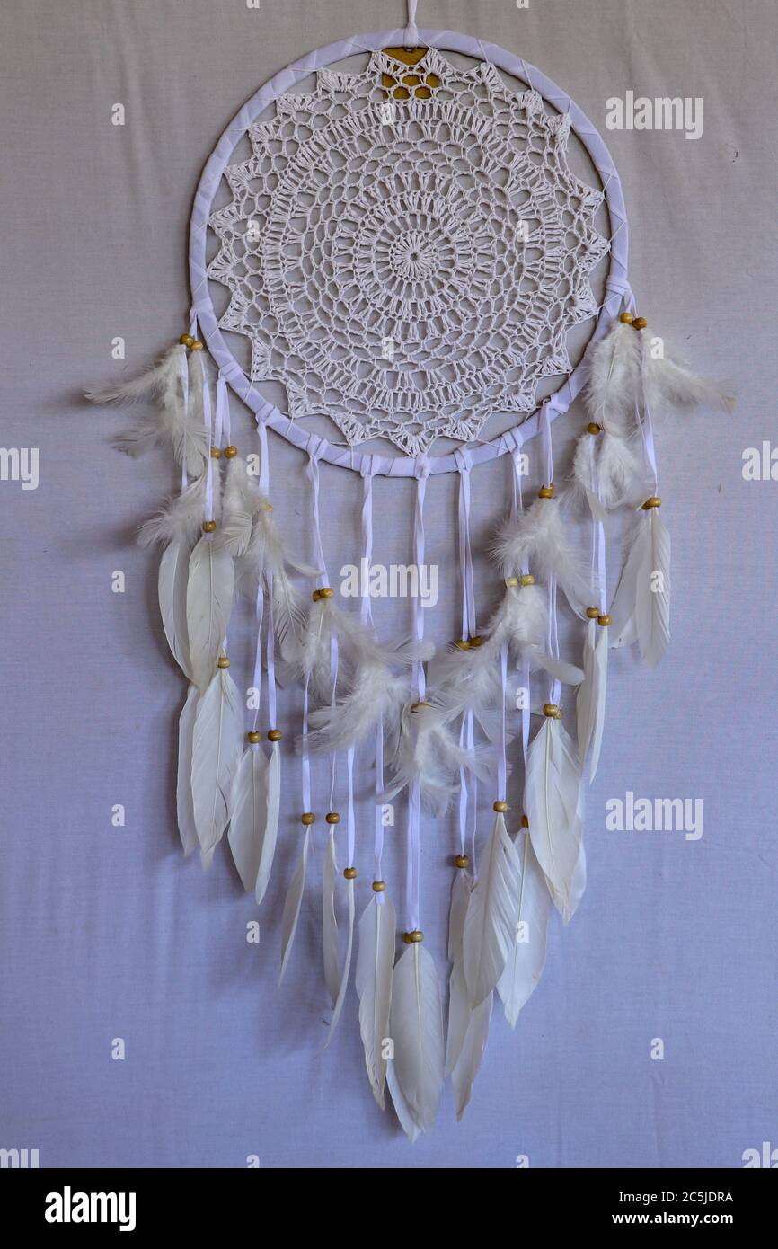 White color dream catcher with white feathers in the interior. Home ...
