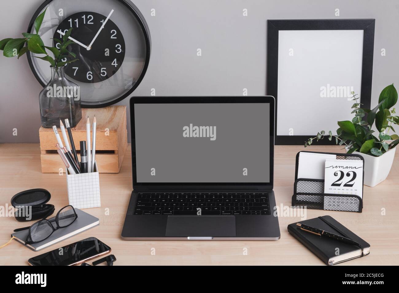 Minimal Office electronics and desk accessories in a woody desk and ...