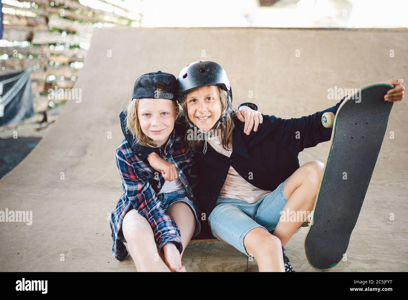 Group of children friends enjoying day at skate park. Youth ...