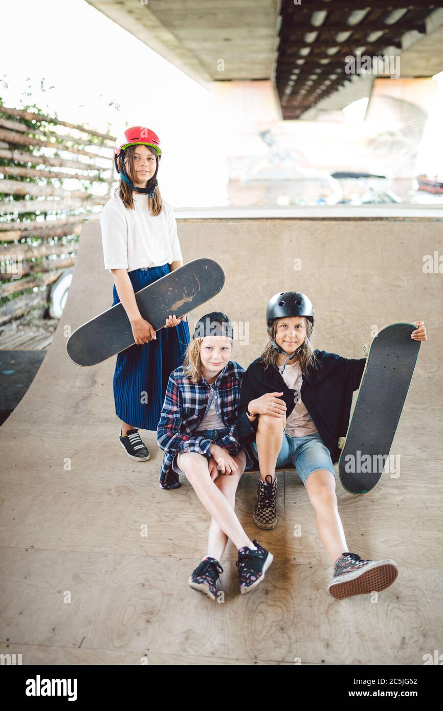 Group of children friends enjoying day at skate park. Youth ...