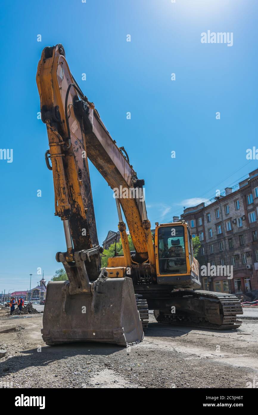 Excavator and his big bucket during the construction of the road ...