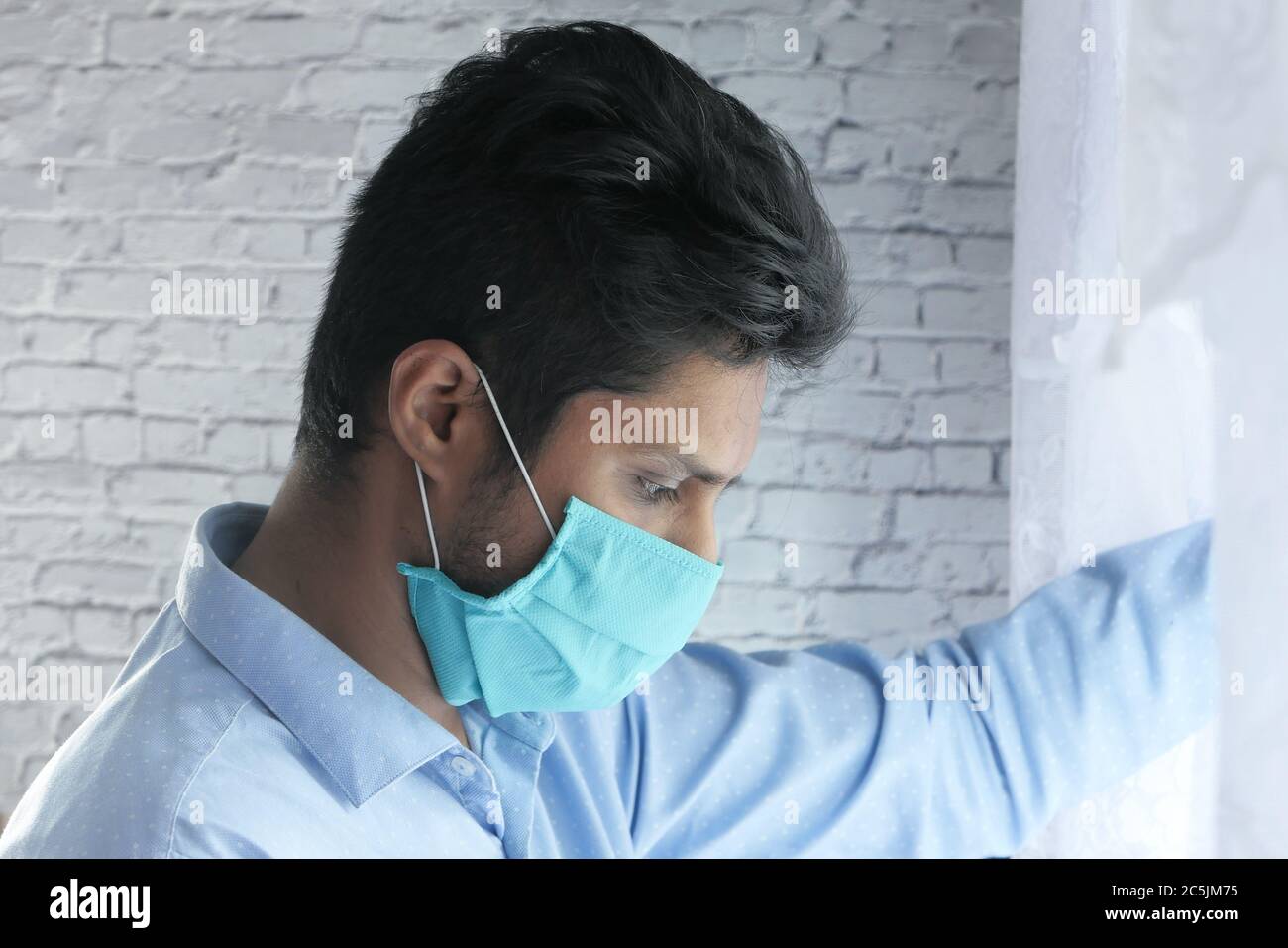 A young asian man with protective mask in face feeling sad Stock Photo ...