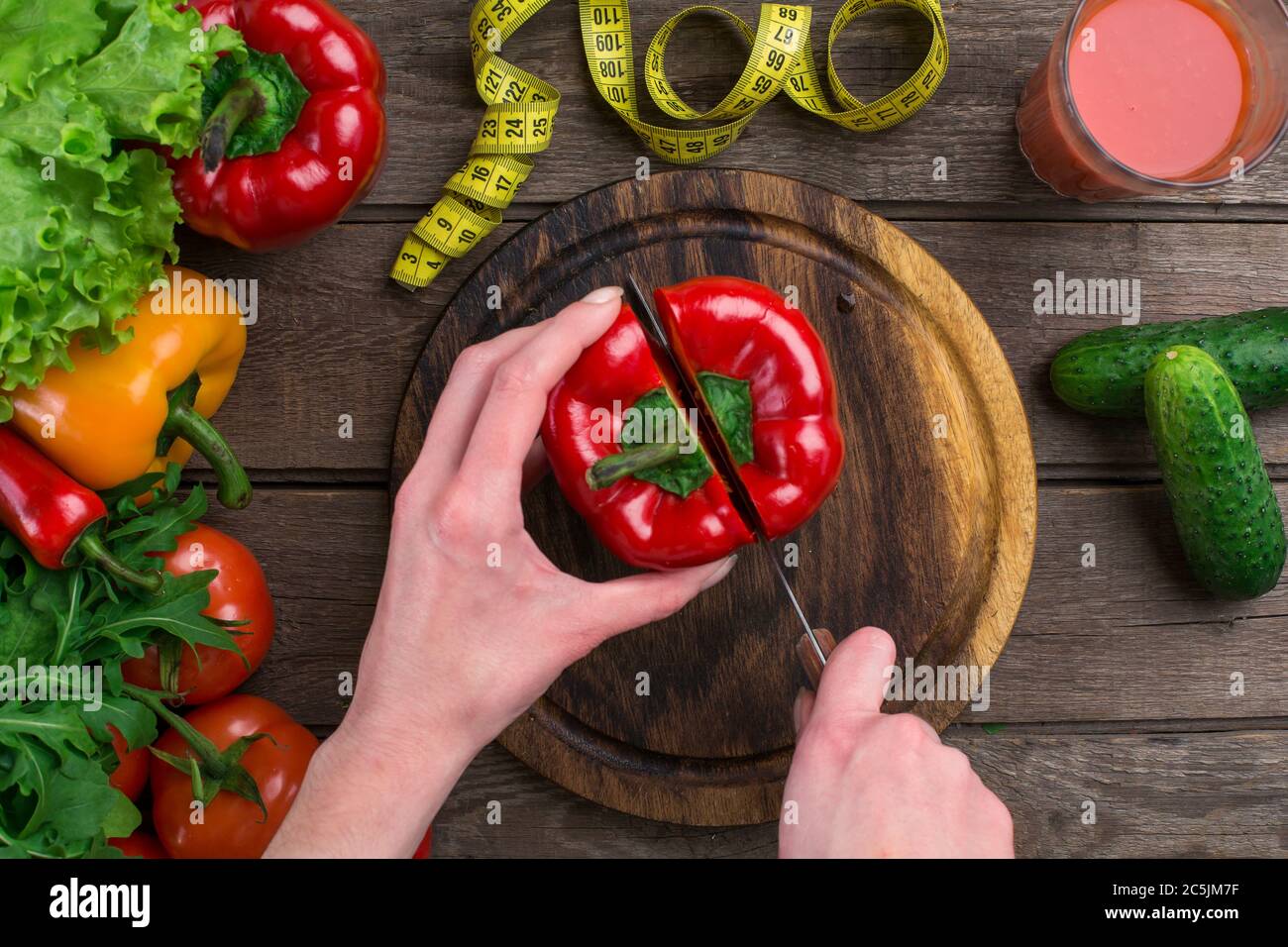 Female hands cutting pepper at table, top view Stock Photo - Alamy