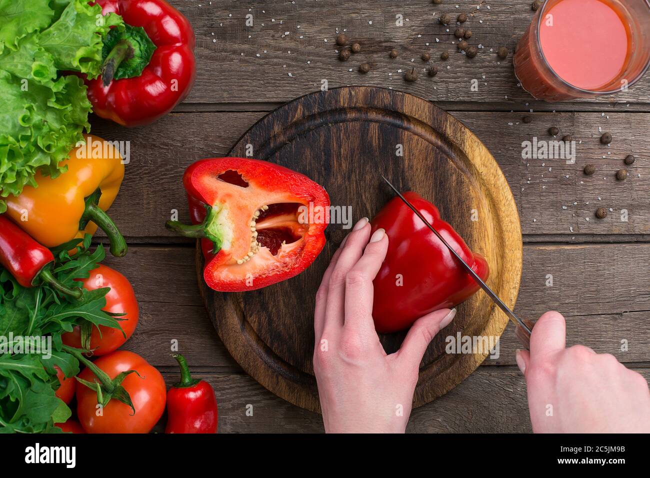 Female hands cutting pepper at table, top view Stock Photo - Alamy