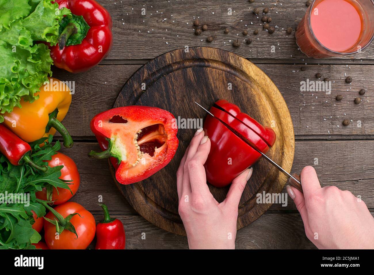 Female hands cutting pepper at table, top view Stock Photo - Alamy