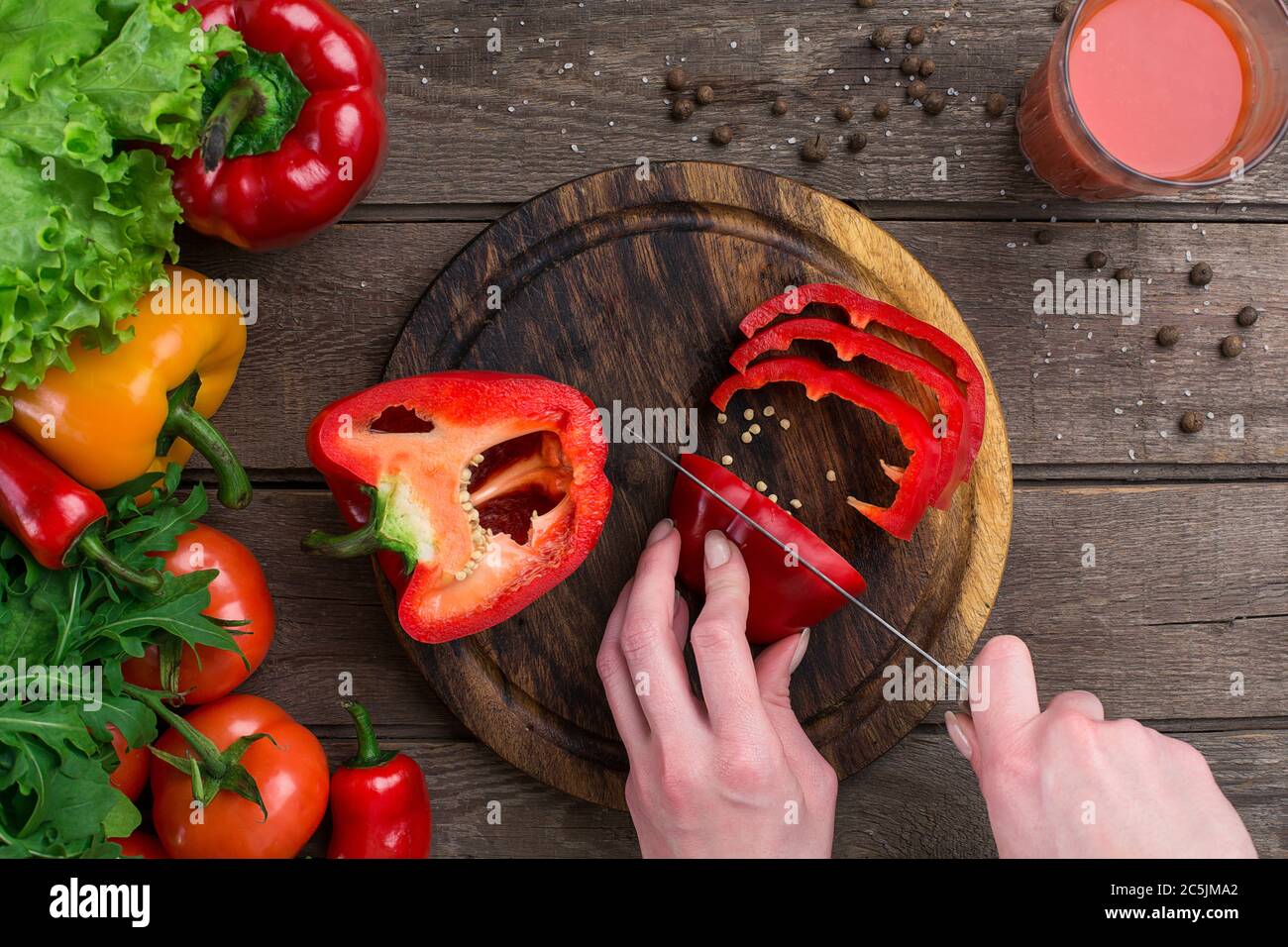 Female hands cutting pepper at table, top view Stock Photo - Alamy