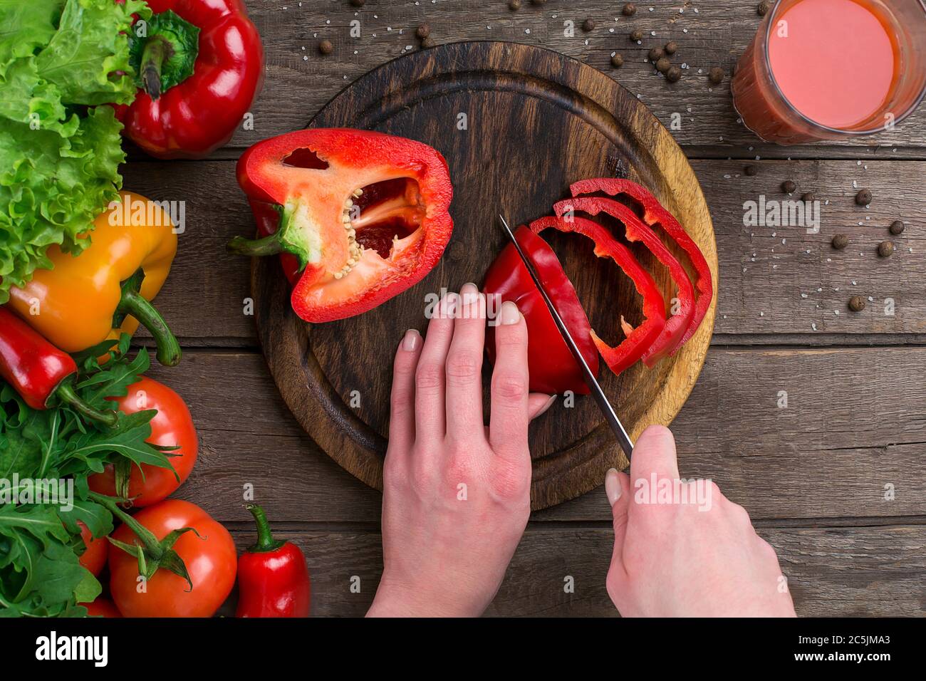 Female hands cutting pepper at table, top view Stock Photo - Alamy