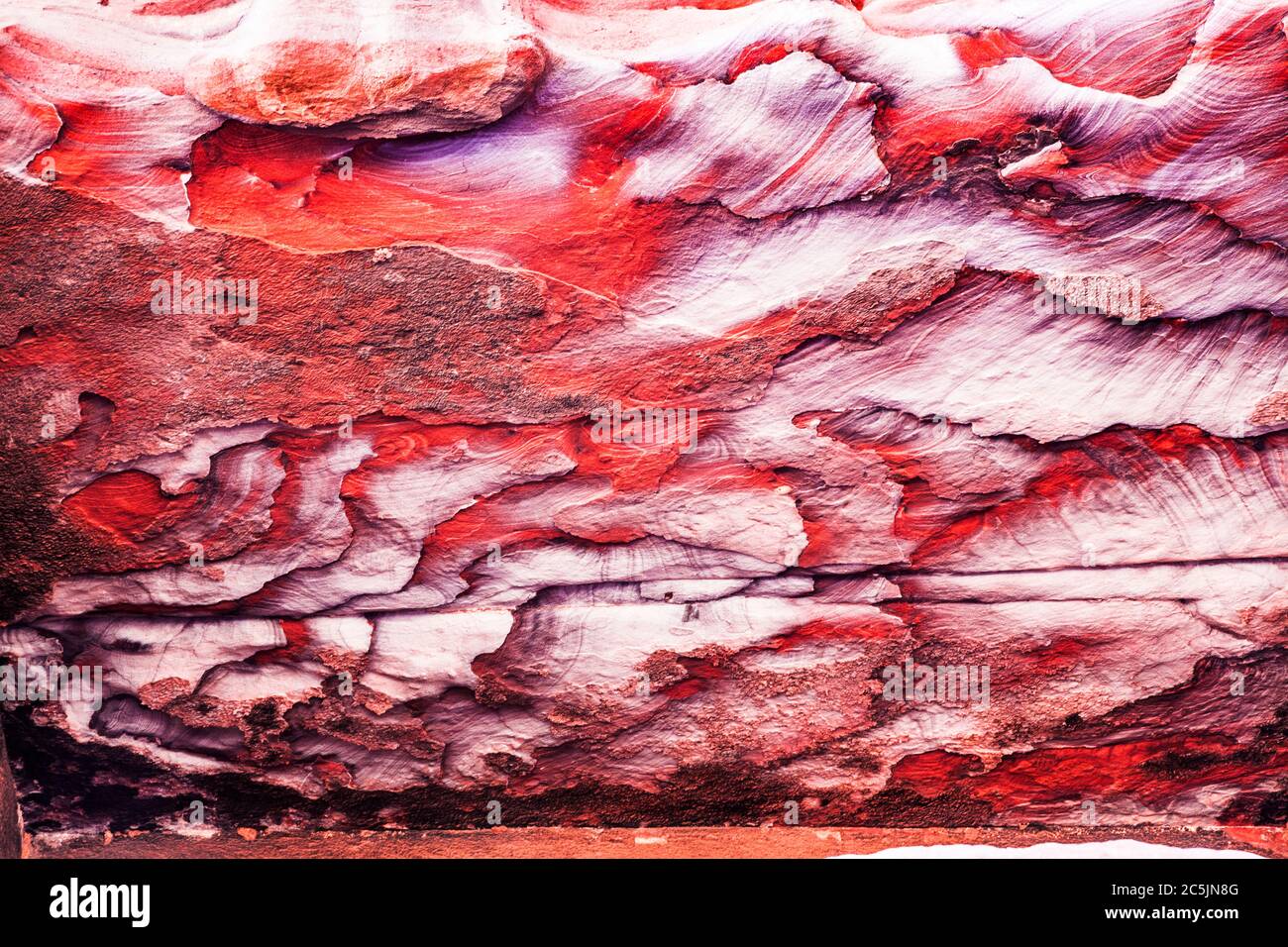 The red sandstone rock surface of the canyon known as Al Siq at the ...