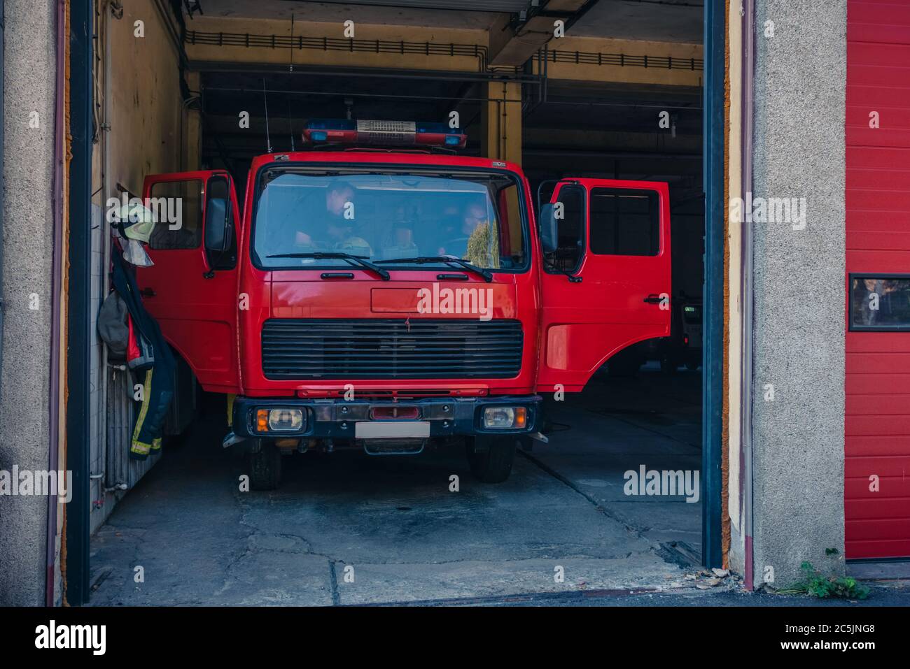 Fire engine inside the garage of the fire department Stock Photo - Alamy