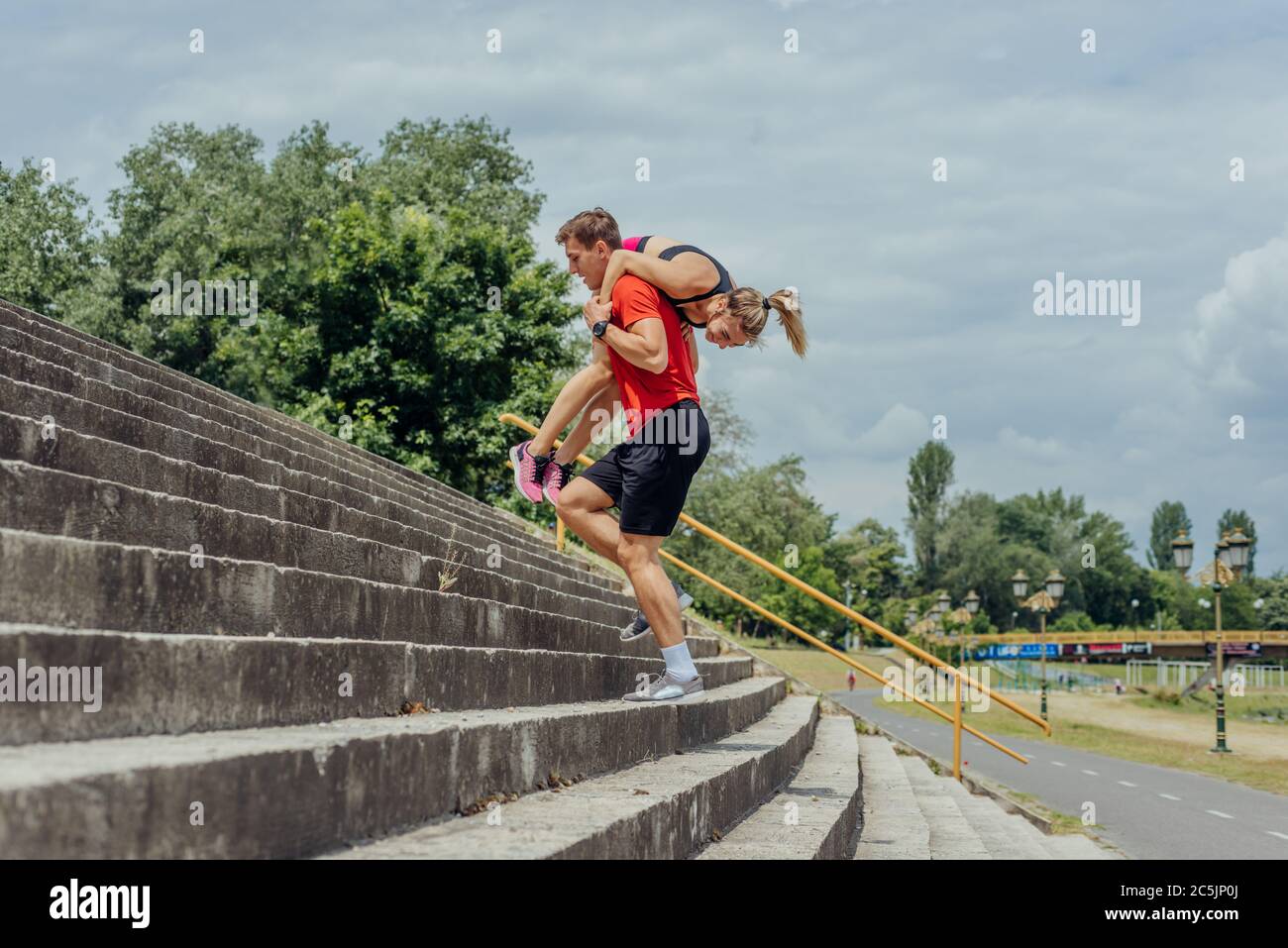 Two friends run up stairs hi-res stock photography and images - Alamy