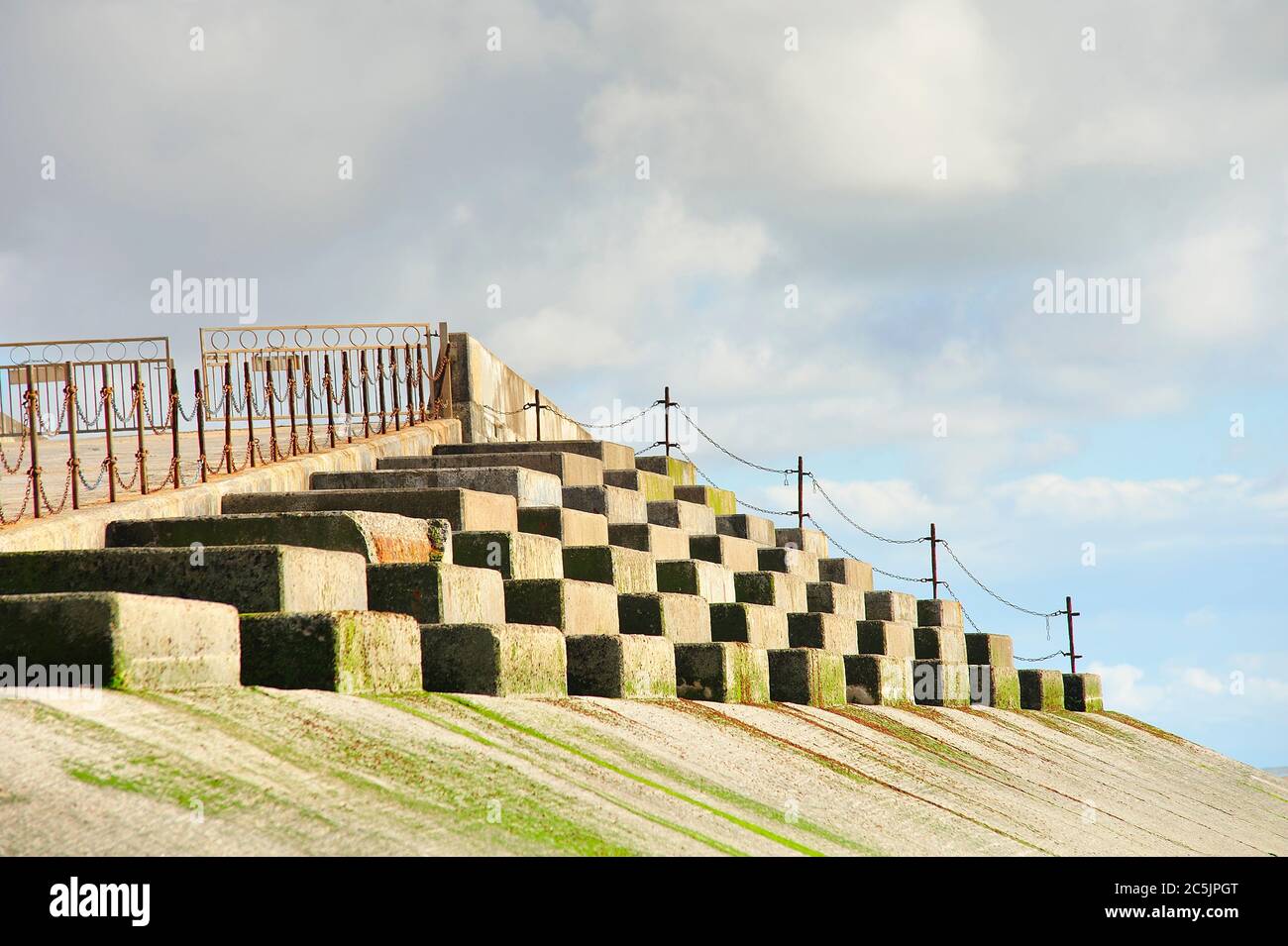 Old seawall with gates and rusty chain link fence against the sky Stock ...