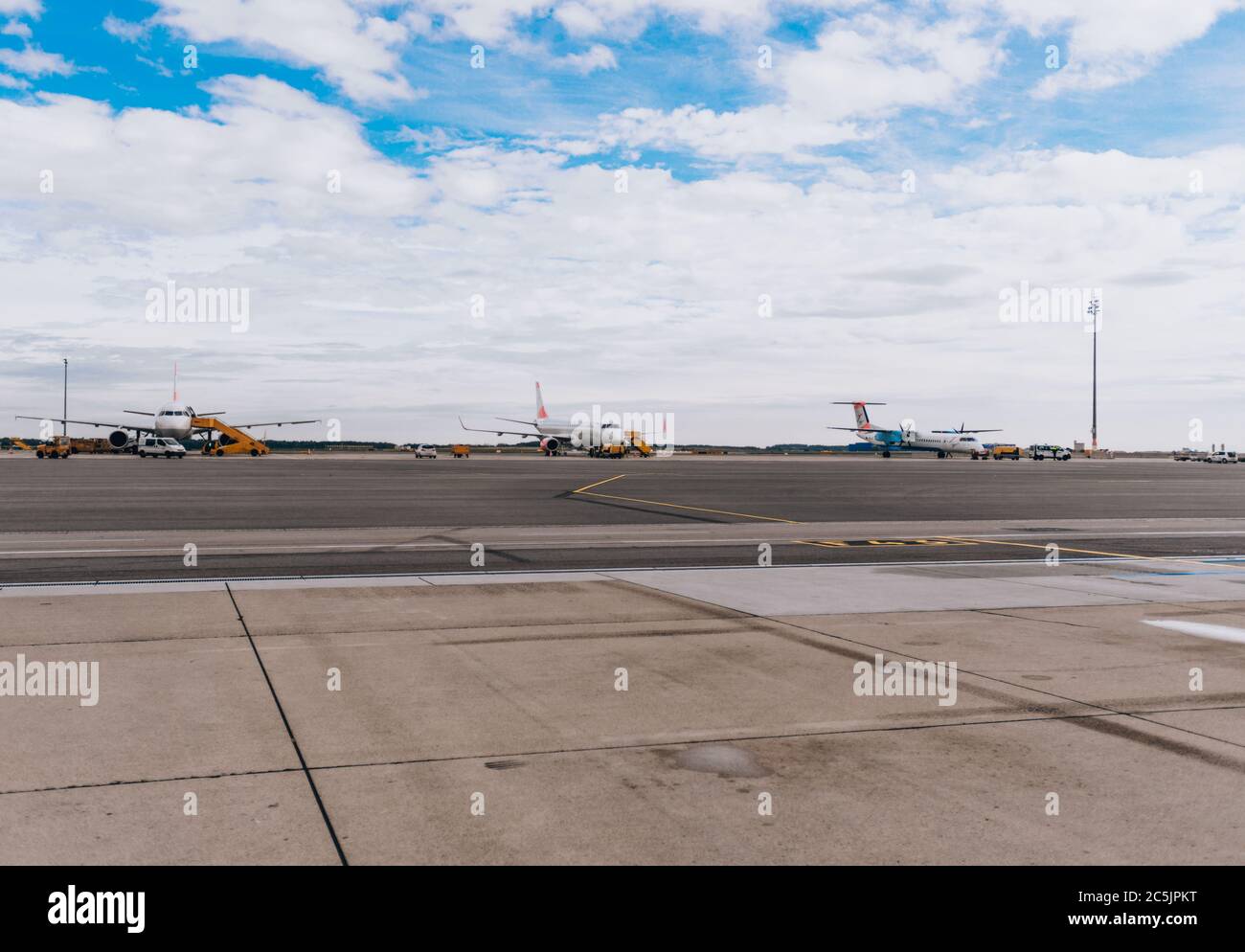 Two jet engine airplanes and one propeller engine airplane at an ...