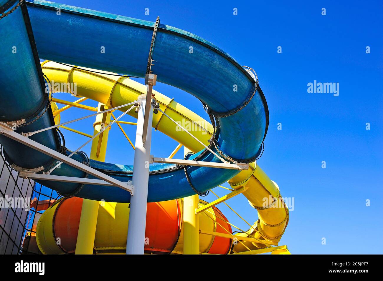 External yellow and blue water slide tubes on water park centre Stock ...