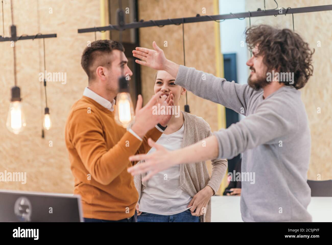 Group of coworkers, colleagues having fun at the office while chatting ...