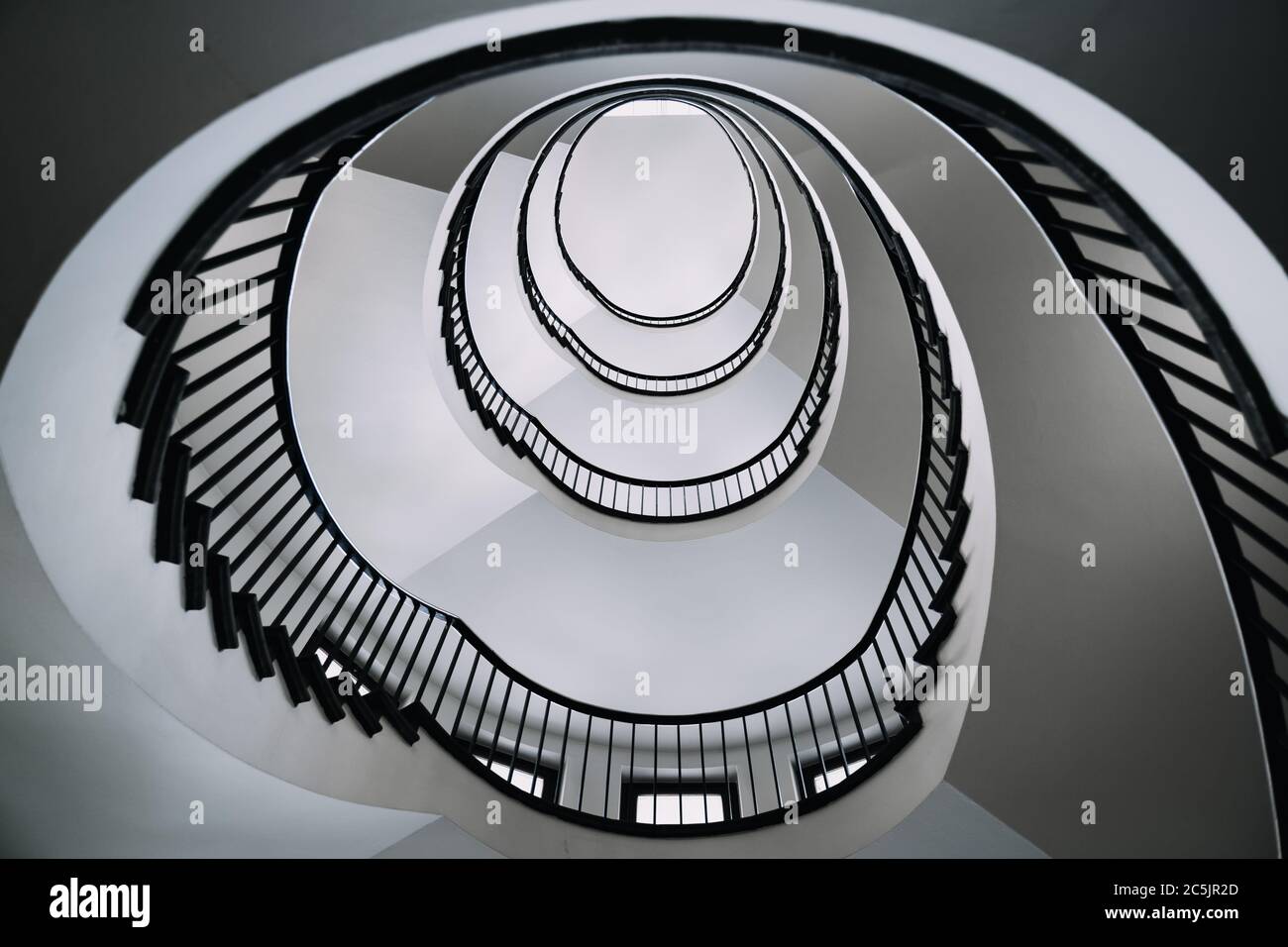 looking deep into long spiral stair case of big building, concept photo ...