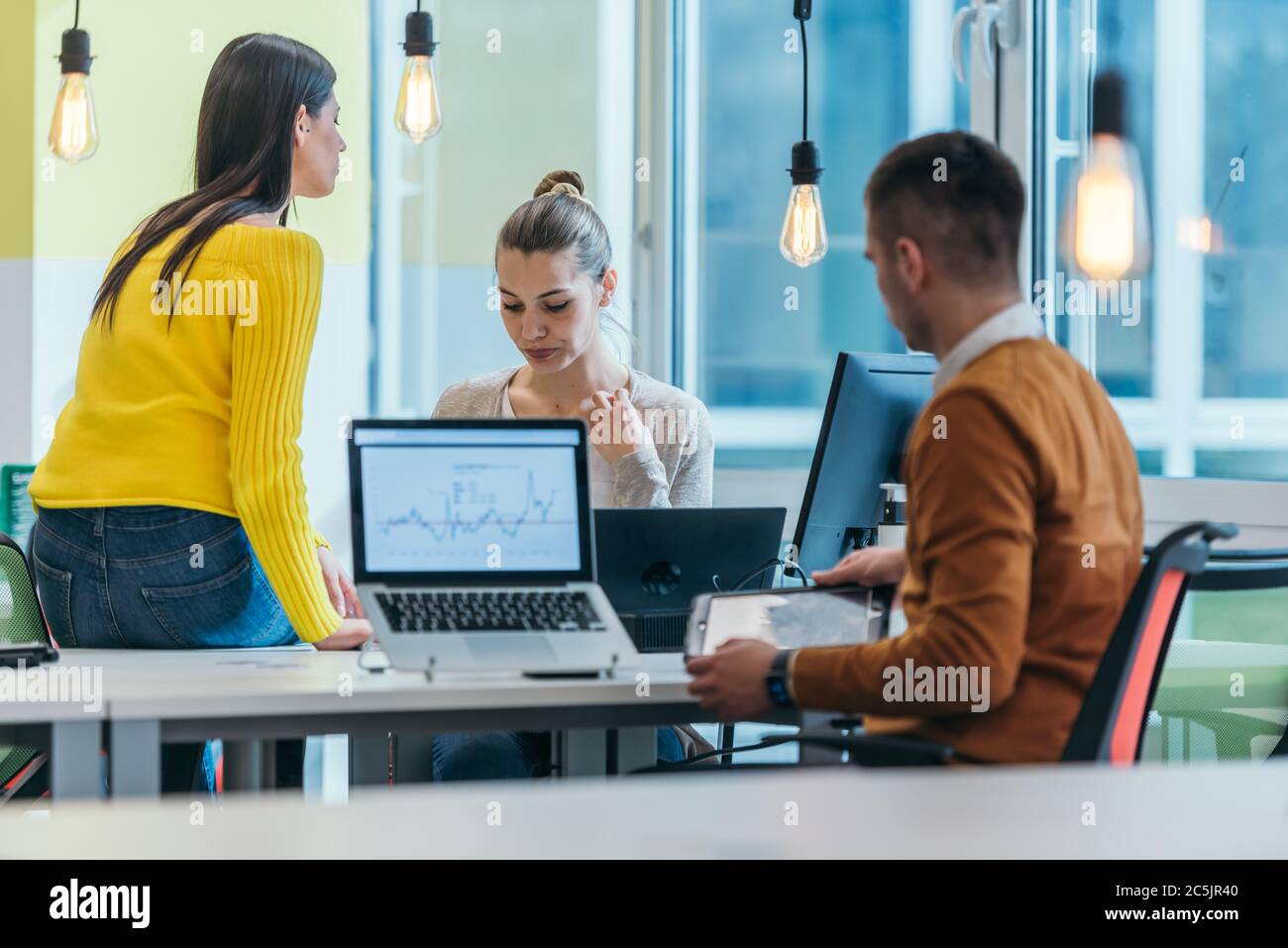 Group of professional coworkers ( team ) working on a desk in a modern ...