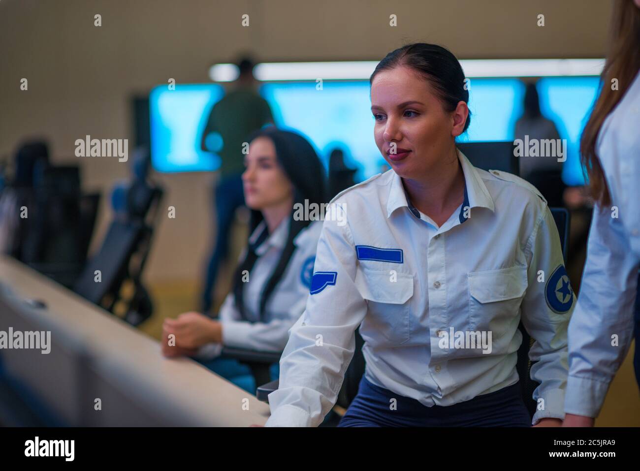 Security guard monitoring modern CCTV cameras in a surveillance room ...
