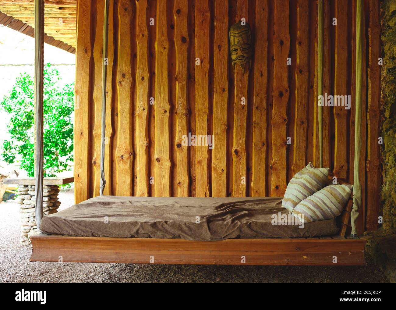 rest zone. rustic wooden hanging bed outdoors Stock Photo - Alamy