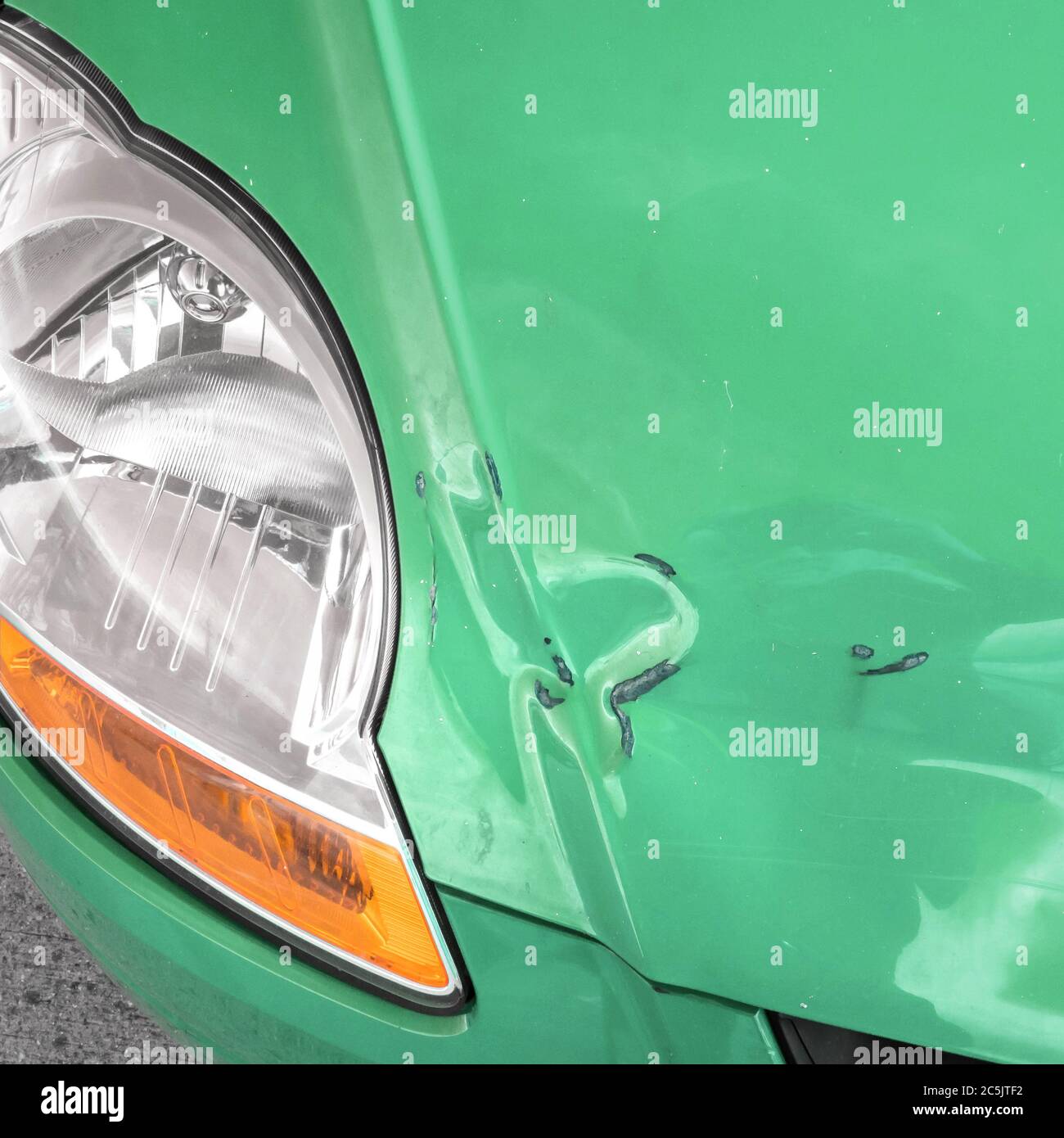 Damaged bodywork. Dents and scratch marks on a car's hood. Close-up ...