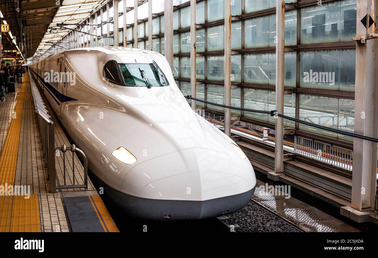 Shinkansen train (Japanese high-speed bullet train) pulling into a ...