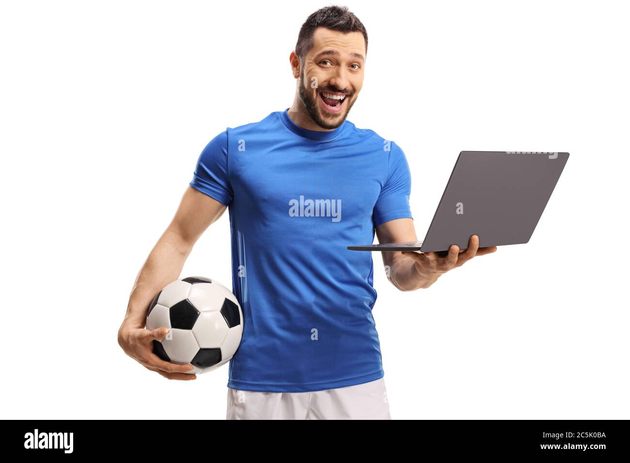 Soccer player holding a ball and a laptop computer isolated on white ...