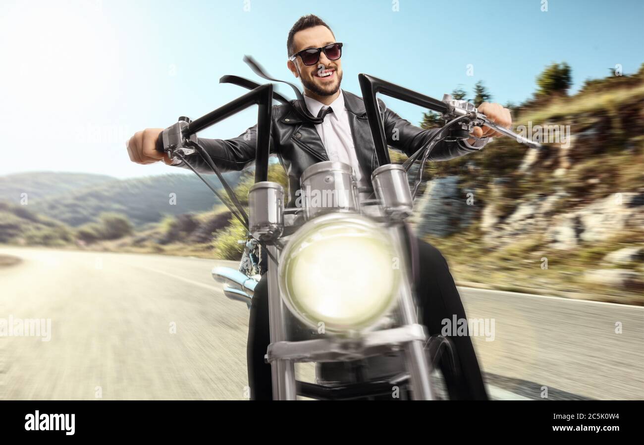 Biker with sunglasses riding a custom chopper on an open road Stock ...