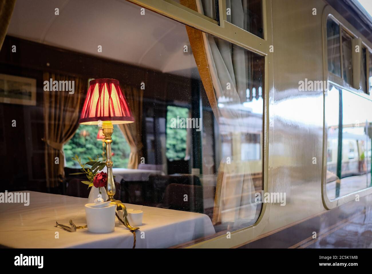 Shallow focus of an ornate, period dining table lamp seen in a First ...