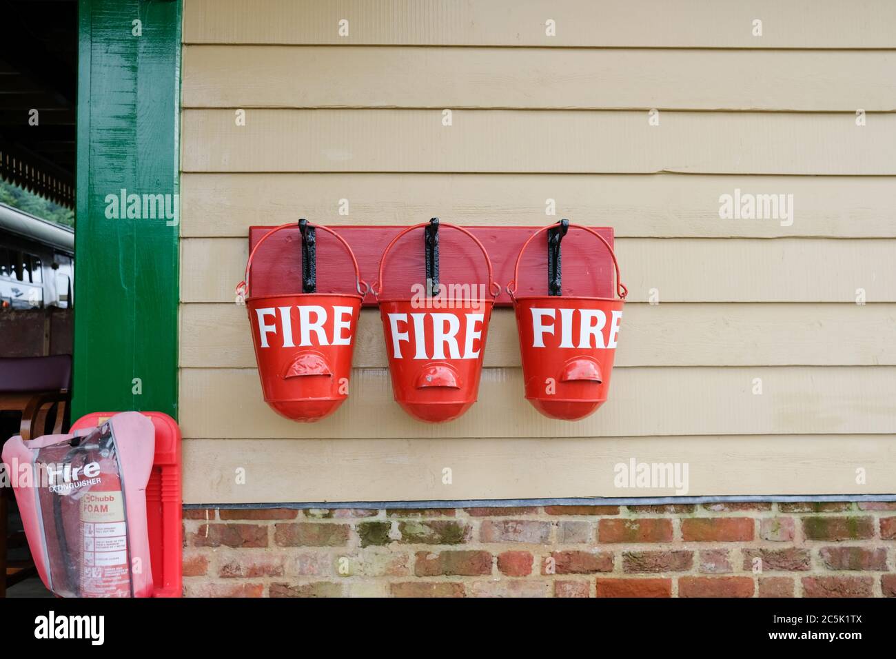 Trio of vintage style Fire Buckets seen hanging outside a timber built ...
