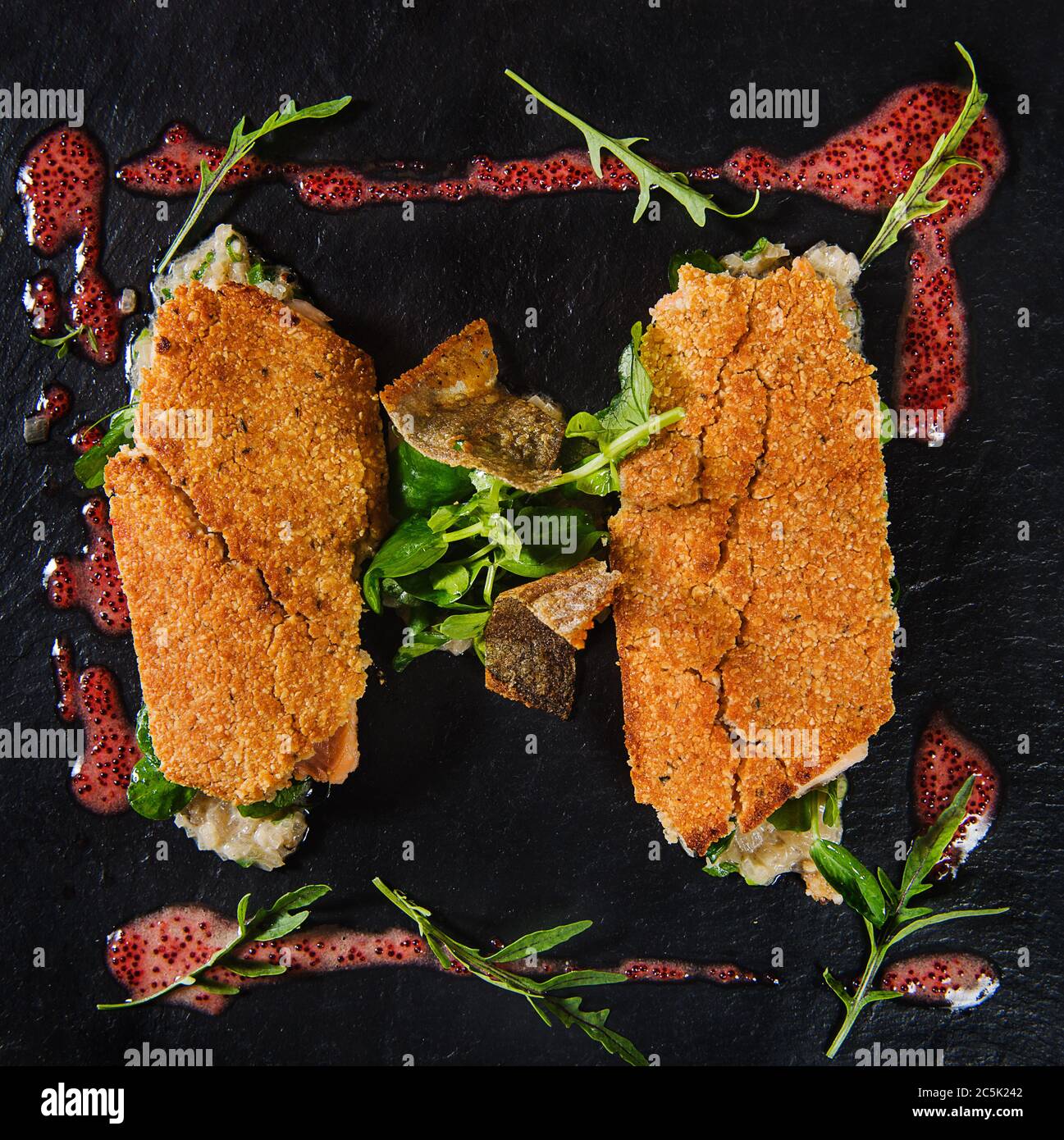 Gourmet fried fish with greens Stock Photo - Alamy