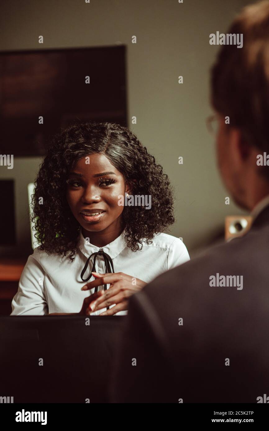 Young African woman in an interview or at business meeting. Selective ...