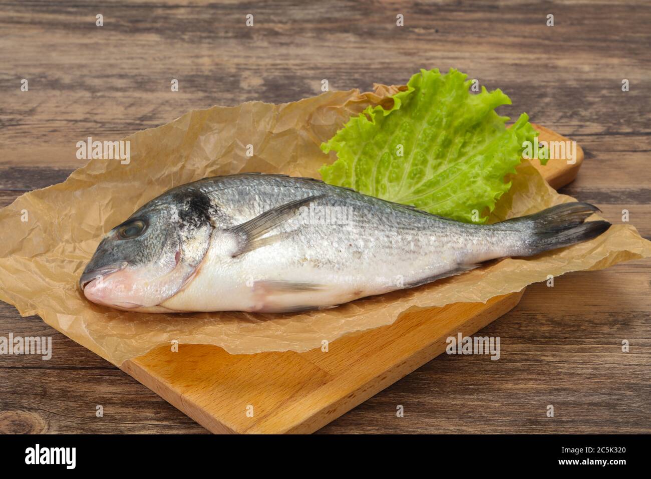 Raw Dorada fish ready for cooking Stock Photo - Alamy