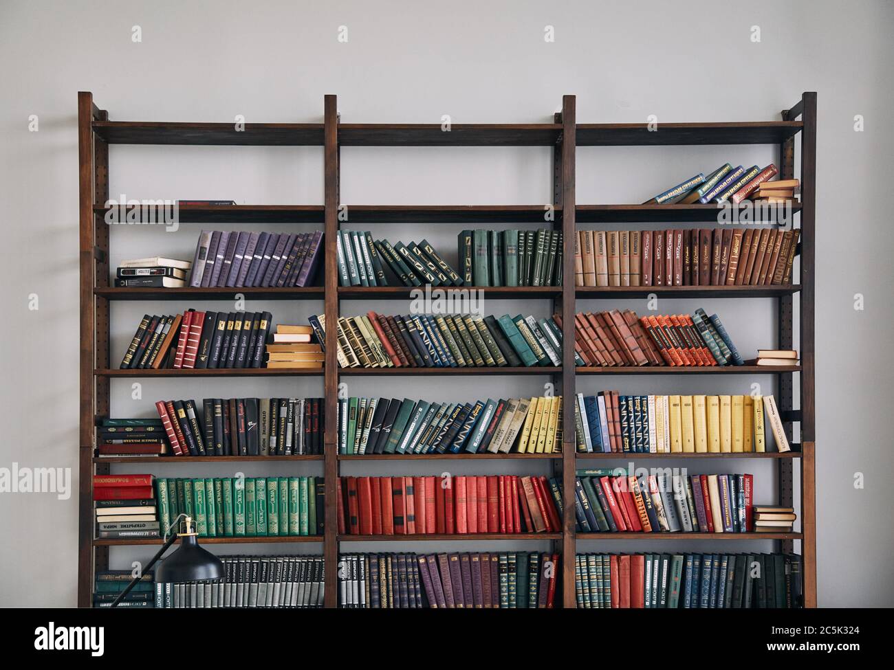 Bookcase with old books on the shelves Stock Photo - Alamy
