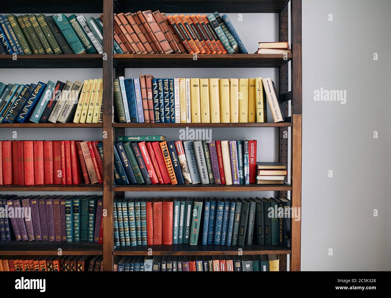 Bookcase with old books on the shelves Stock Photo - Alamy