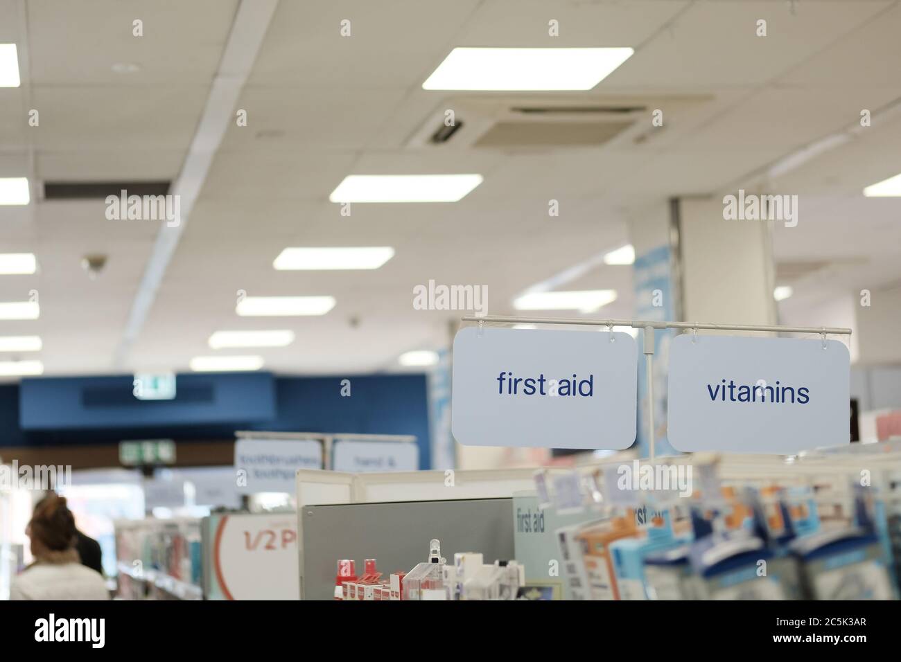 Shallow focus of a First Aid and Vitamins sign located within a well ...
