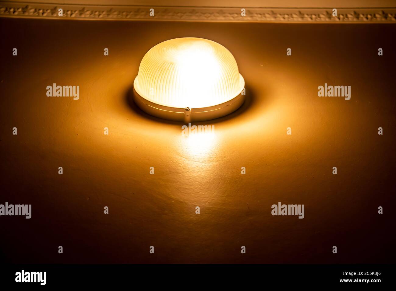 Terrible light on the wall. The old lamp on the wall with yellow light ...