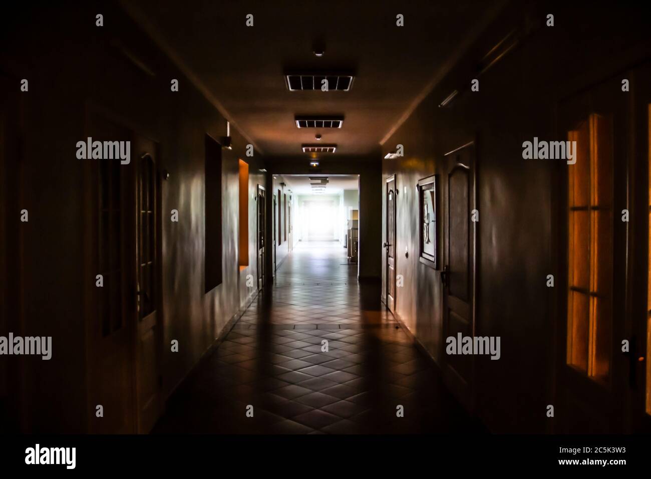 Dark corridor in the hospital. A long terrible corridor with light from ...
