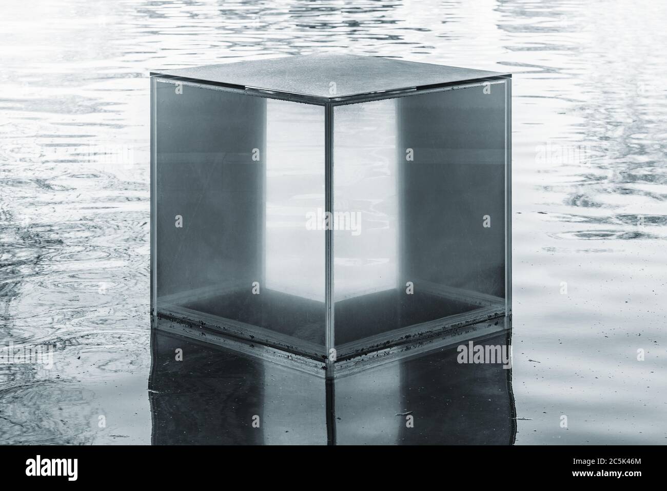 Cube made from glass on the water surface Stock Photo - Alamy
