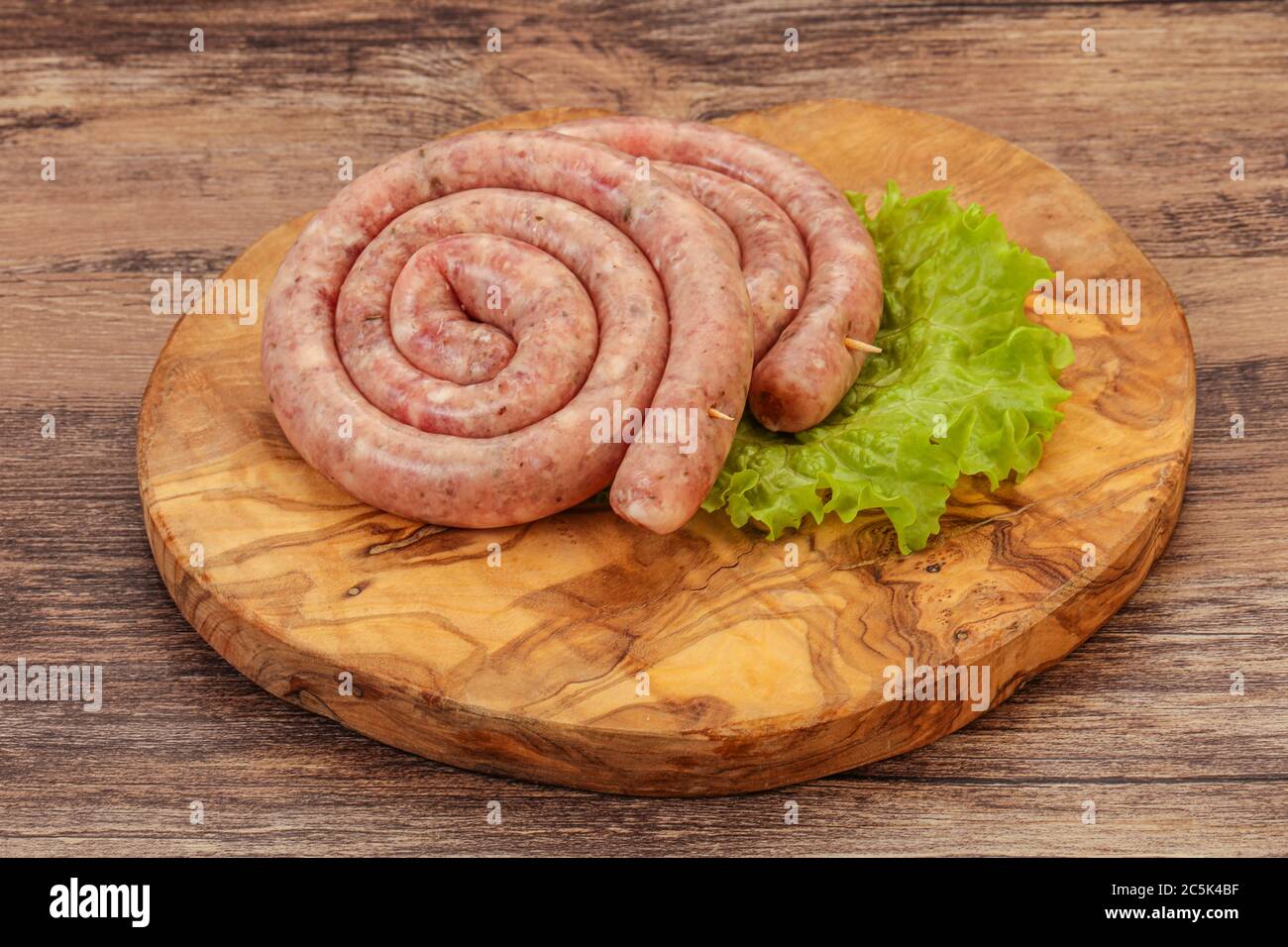 Raw pork sausage ring for grill Stock Photo - Alamy