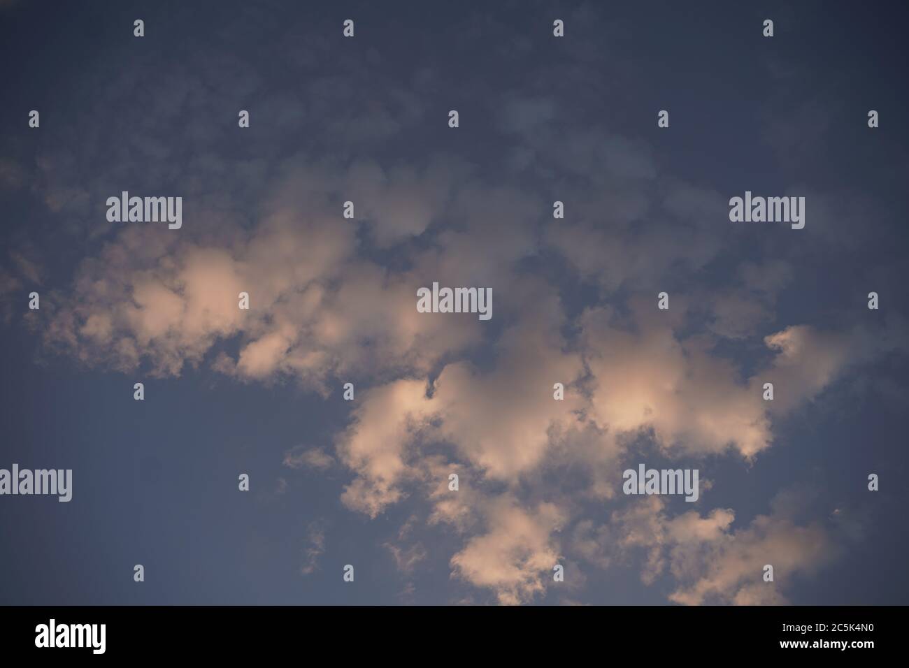 Soft clouds backlit by sunlight in the evening sky. Beautiful cloud ...