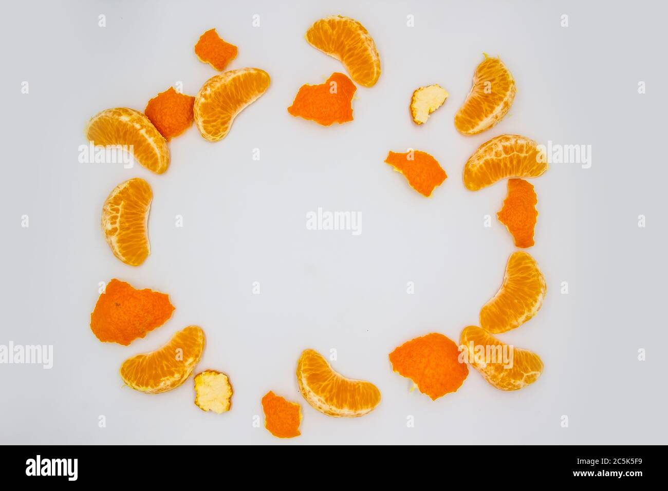 A frame from peel's tangerines and mandarin pieces on white background ...