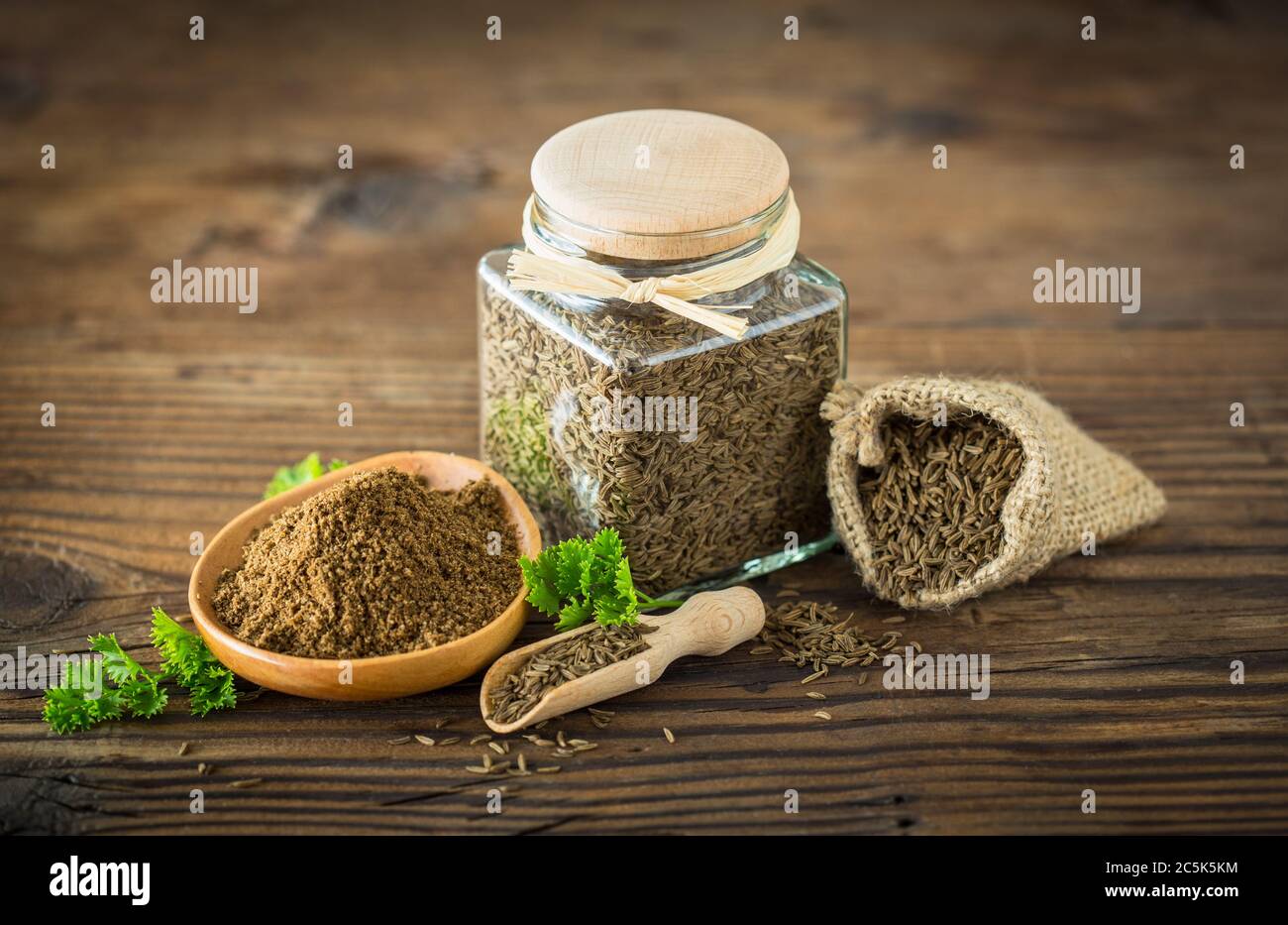 Fresh cumin seeds and powder on the wooden table Stock Photo - Alamy