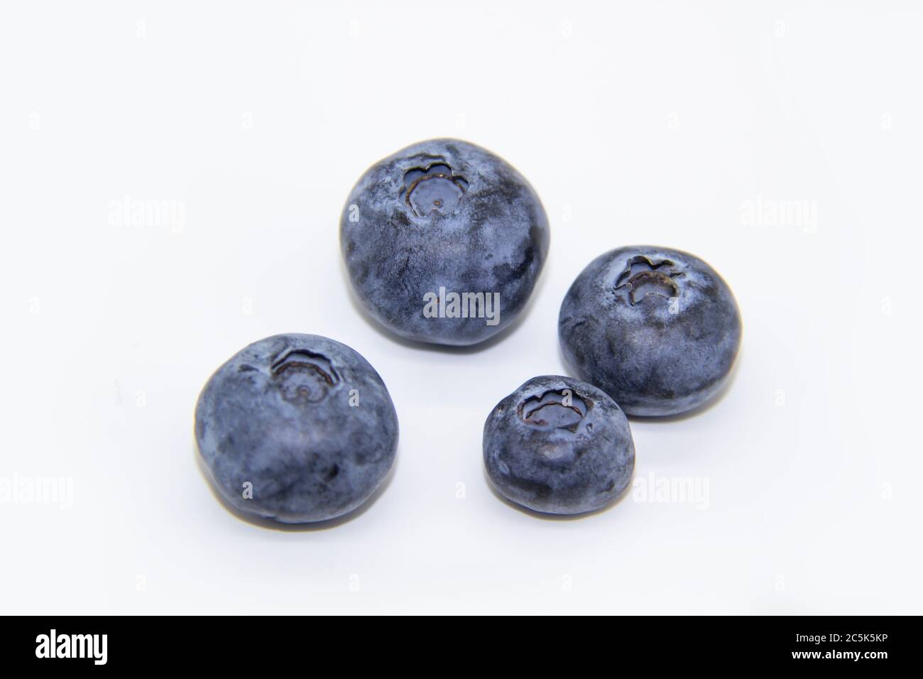 Fresh blueberry on white background. A composition of the four ...