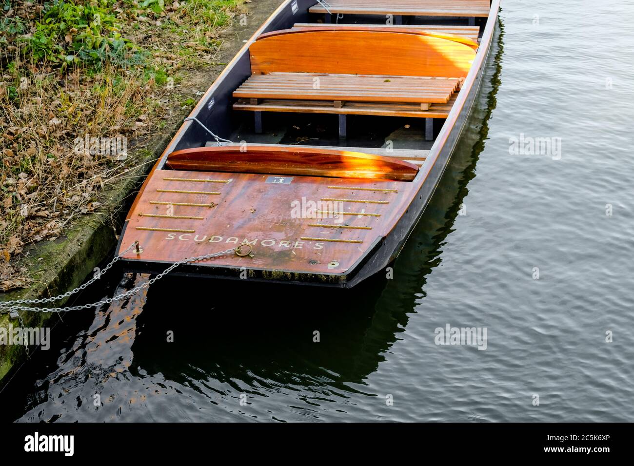 Large, wooden Punt seen moored up on a Cambridge river, near the famous ...