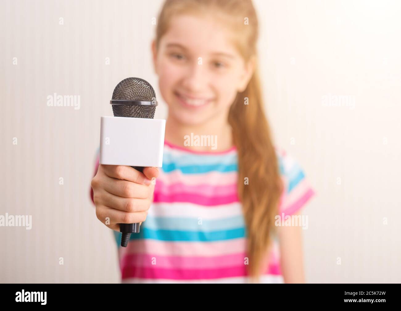 Little journalist taking interview with microphone Stock Photo - Alamy