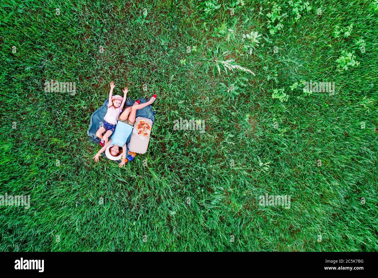 two little girls on a green grass, aerial top view Stock Photo - Alamy