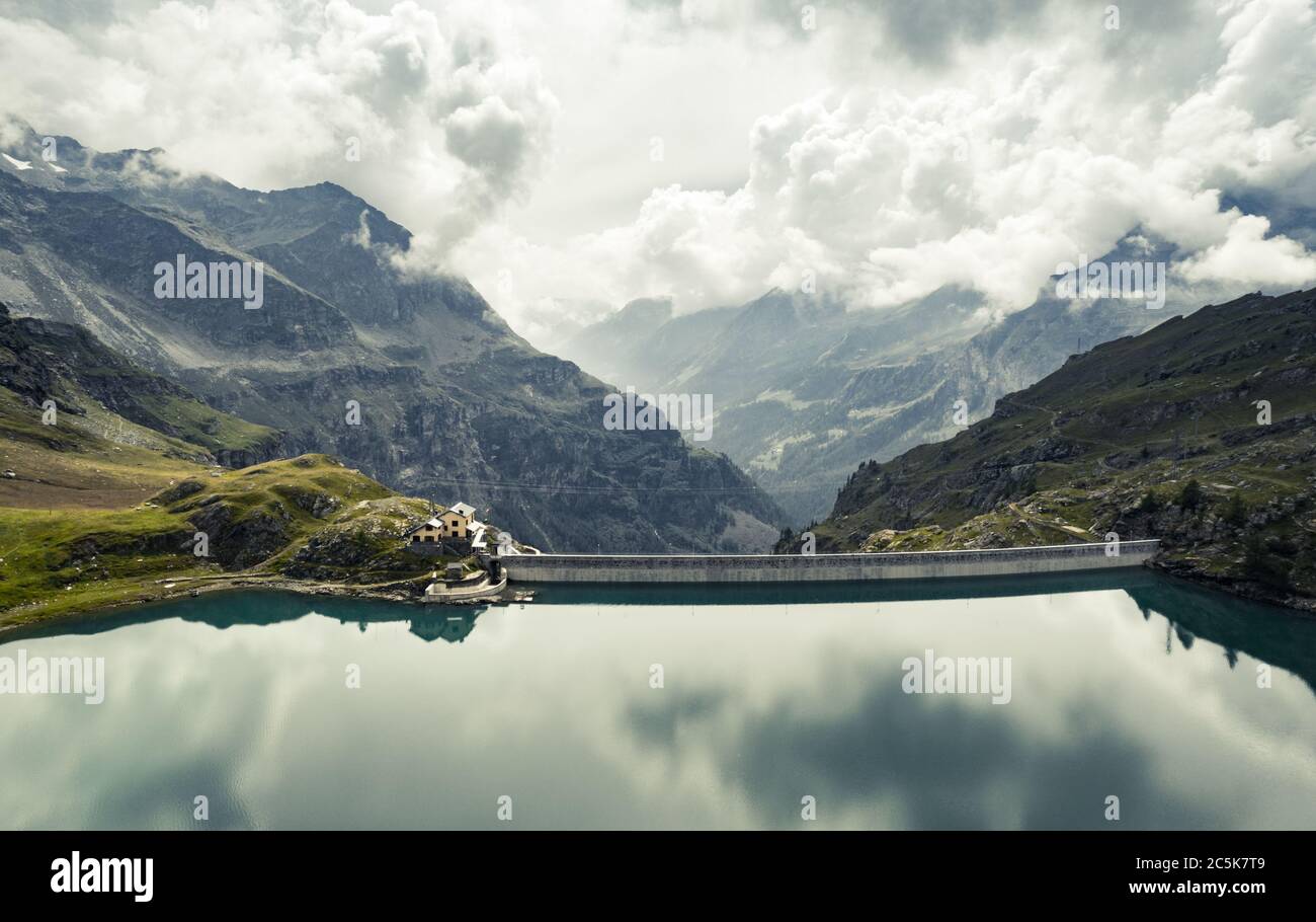 Panoramic view of man made dam in alpine mountains Stock Photo - Alamy